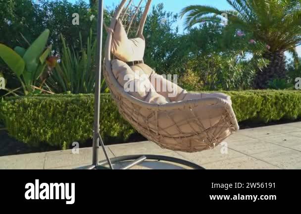 Luxurious hanging rocking chair, next to the clean pool and villa ...