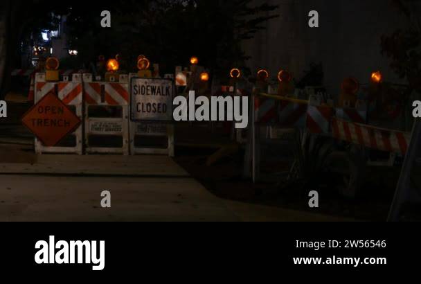 Amber lights flashing on caution signs in a road construction zone at ...