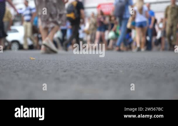 Low angle view of unrecognizable pedestrians crossing intersection in ...