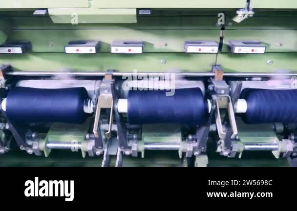 Spools with coloured threads installed into the sewing mechanism ...