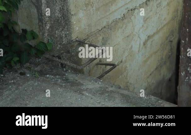 Close-up of an old concrete wall with reinforcement in the form of ...