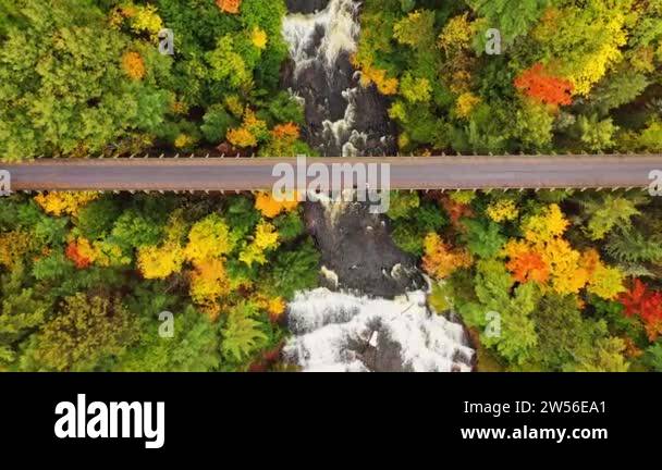Beautiful rising up aerial look down of a man on the abandoned railroad ...
