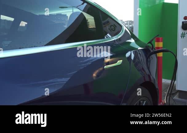 Electric vehicle charging port plugging in EV modern car. save ecology ...