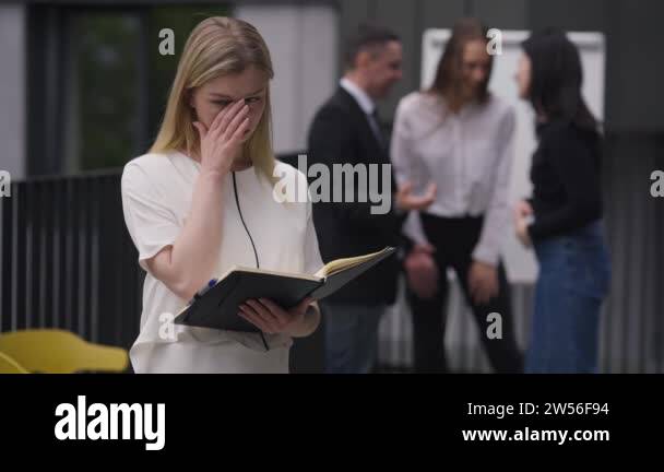 Stressed sad beautiful young woman crying standing outdoors with ...