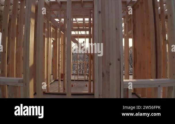 unfinished frame house interior with wooden beams of roof and walls ...