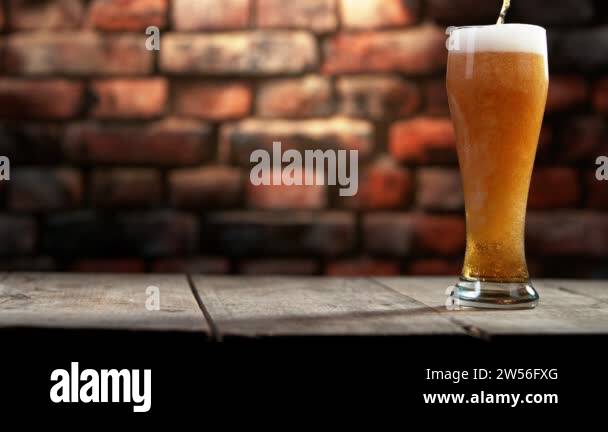 Super slow motion of pouring beer into glass, old cellar interior ...