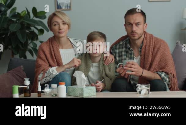 Sick family waving and looking to camera while sitting and and having ...