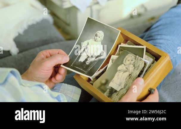 an elderly man looks through his old photographs of 1960-1965, the ...