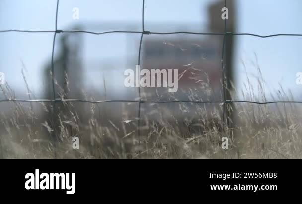 MAGA Sign Rack Focus. Through a wire farm fence a sign reads, "VOTE TO ...