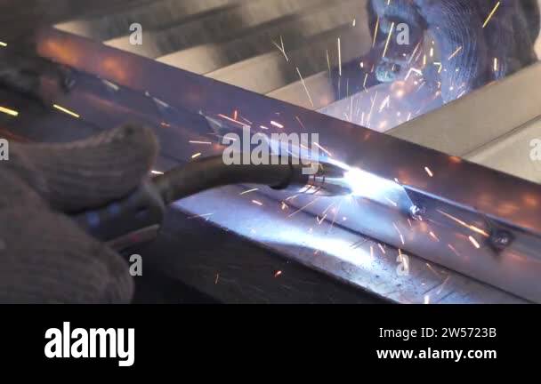 Close-up work with metal steel and iron using a welding machine, bright ...