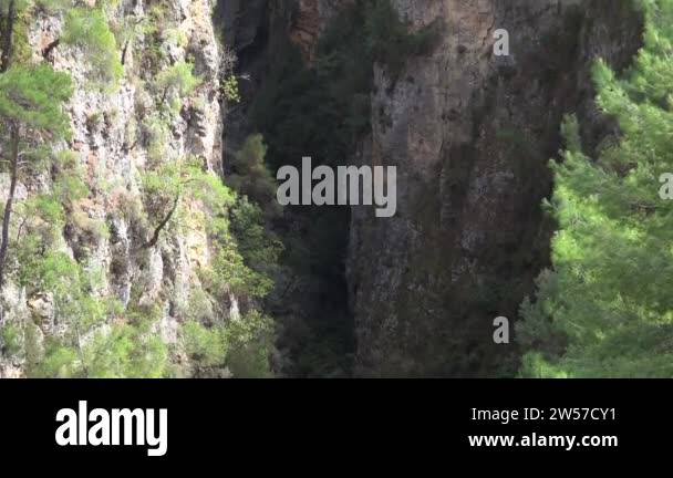 Deep and steep rocky canyon wall. Gorge is a deep cleft between ...