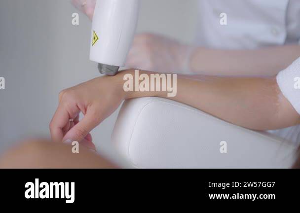 close-up. laser hair removal under the armpit of a beautiful girl in a ...