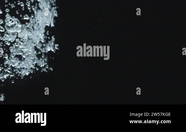 Close up slowmo of air bubbles falling down and raising upwards in ...