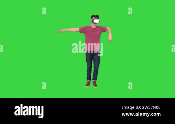 Casual gamer dancing locking hip-hop in VR headset playing dancing game ...