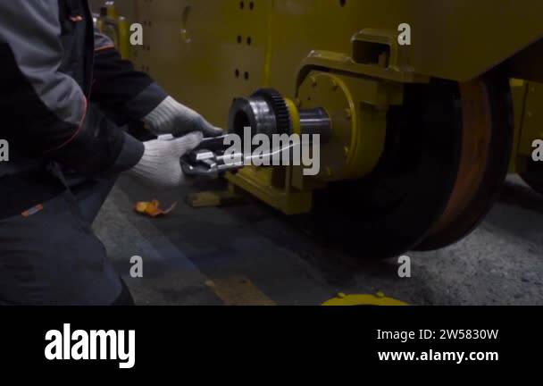 Fixed wheel of locomotive. Clip. Worker checks reliability of train ...