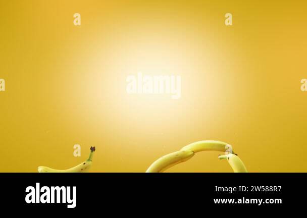 Flying of Bananas in Yellow Background. Speed up and falling down ...