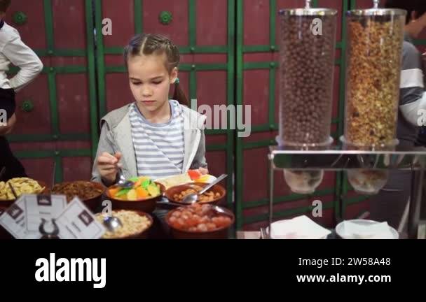 breakfast, buffet in hotel. teen girl without mask, and other visitors ...