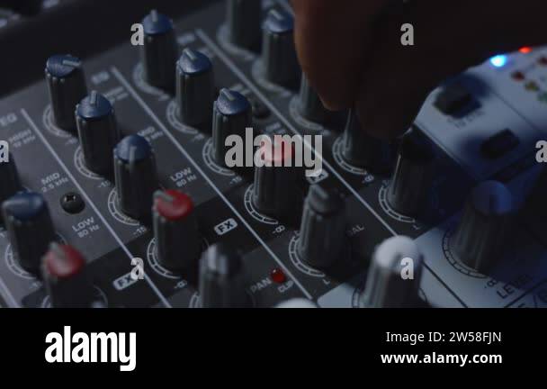 Close-up of fingers adjusting sound mixing console. Mixer console for ...
