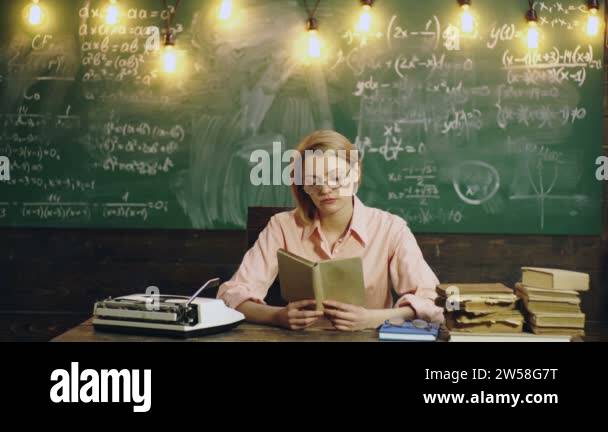 Female university professor preparing for class. Female teacher sitting ...
