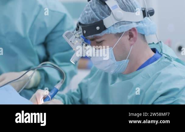 Operation to remove tonsils. In modern clinic under deep anesthesia ...