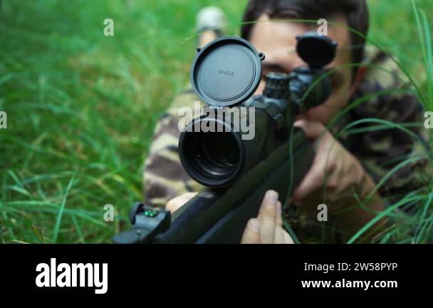 male sniper looking through the scope of his sniper rifle Stock Video ...