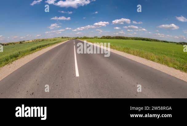 slow transformation of landscape into tiny planet on asphalt road among ...