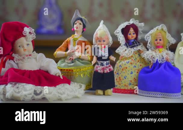 Panorama of dolls lined up in a row. Dolls in clothes of different ...