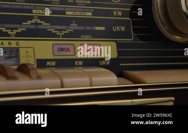 Hands using analog vintage radio. Tuning the frequency of an analog ...