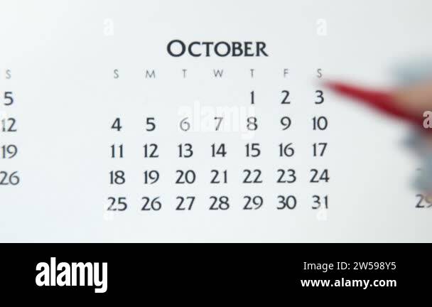 Female hand circle day in calendar date with a red marker. Business ...