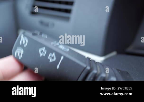 Male driver using turn signal switch. Turning on the right car turn ...