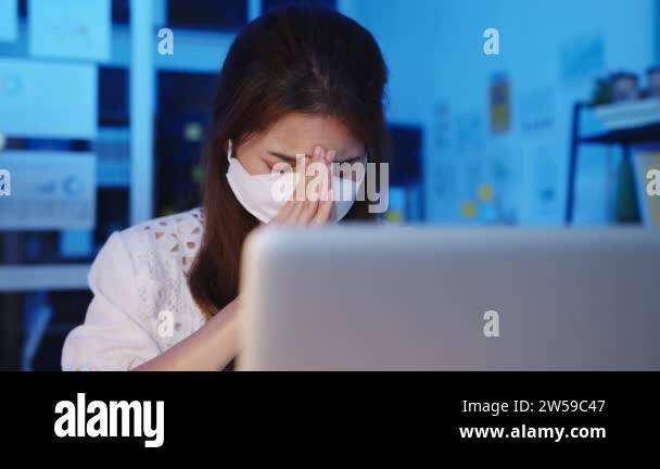 Freelance Asia women wear face mask using laptop hard work at new ...