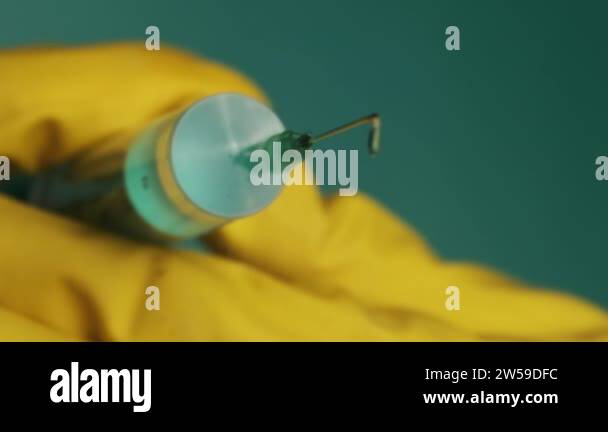 Syringe Needle with Liquid Dripping Drops of Medication in Doctor Hands ...
