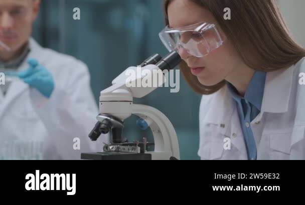 microbiologists are researching virus and bacteria in laboratory, woman ...