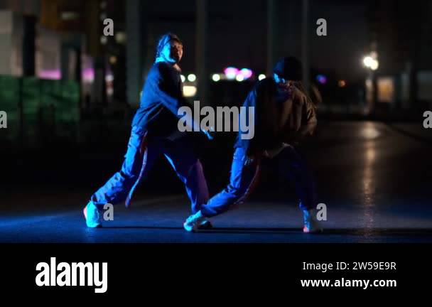 Duet of two young beautiful women dancing hip hop, freestyle on the ...