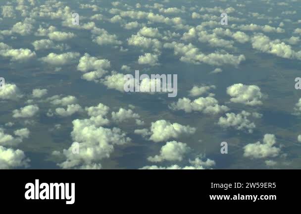 Flying above the clouds in a commercial airplane at dusk. Actual high ...