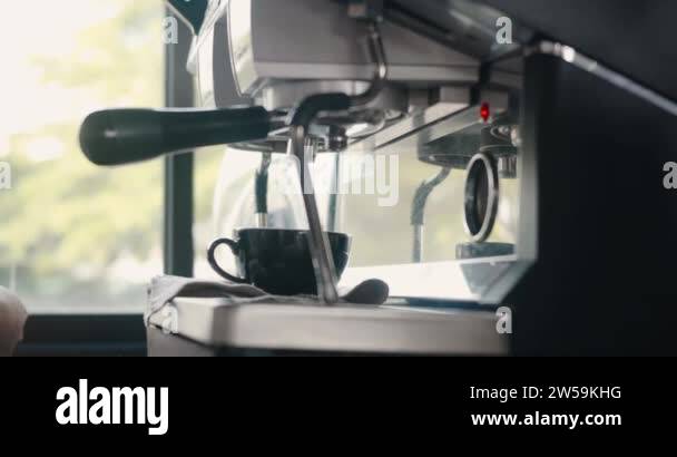 Hand of barista cleaning steam and smoke warm the milk from coffee ...