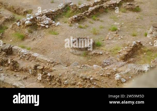 Tourists viewing historic site, ancient building remains excavated by ...