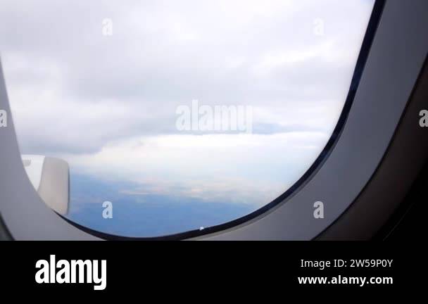 View from the window of a passenger plane flying through the clouds ...