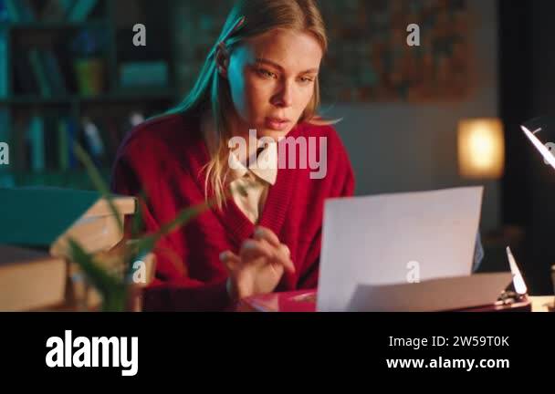 Attractive lady student very concentrated analyzing her college project ...