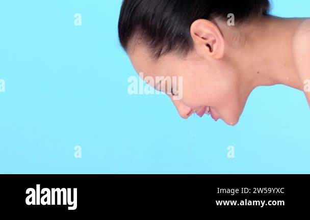 Woman washing her clean face with water. Young adult girl is washing ...