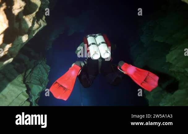 Technical diver in red flippers in the underwater cave of Budapest ...