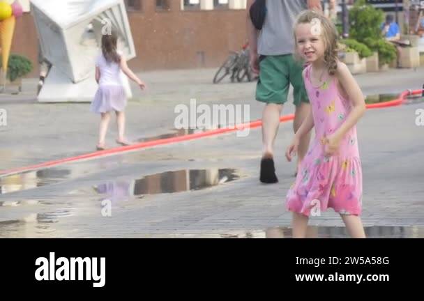 Two Little Girls are Playing in a Puddle Stock Video Footage - Alamy