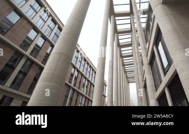 Facade of a building with marble columns. Action. Bottom view of a ...
