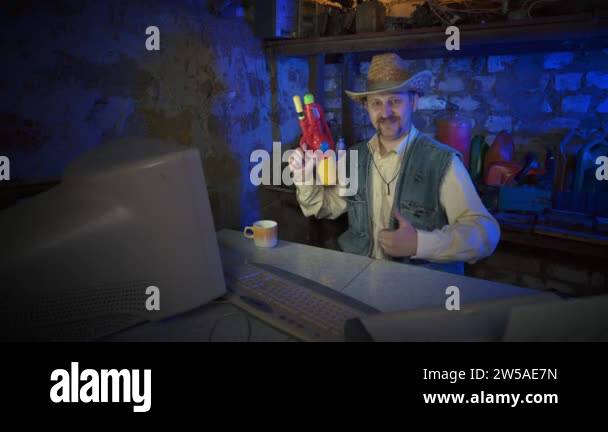 A cowboy in a straw hat near the computer raises his thumbs up. A funny ...