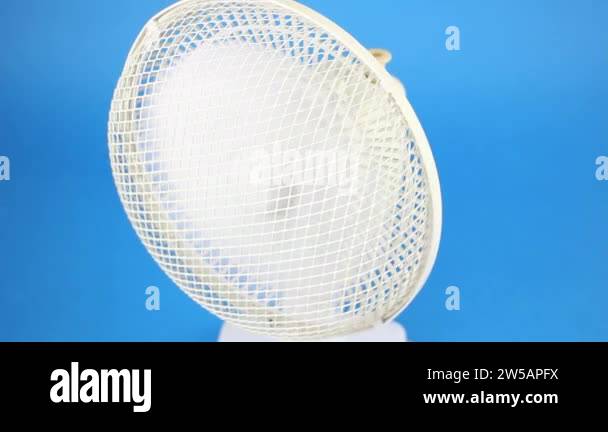 rotating retro fan ventilator on blue screen background, vintage ...