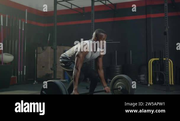 Muscular young black man exercises working out with lifting weights ...