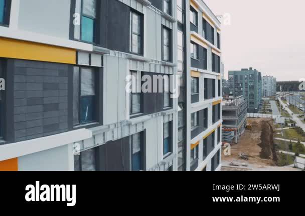 Construction site, building work process modern an apartment panel house on town street ...