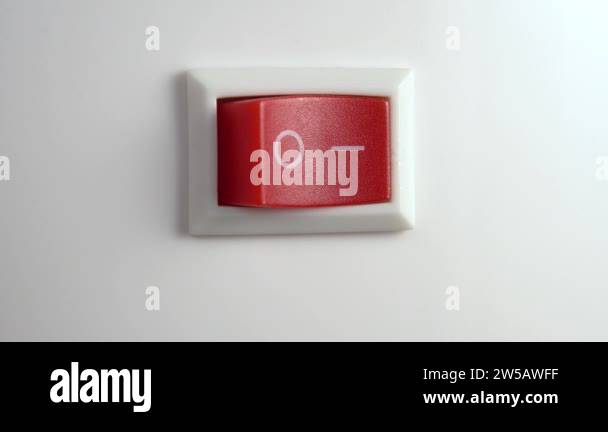 Red switch off. Pressing the button to turn off the device. Macro shot ...