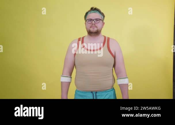 Funny fat man in sportswear with dumbbells in his hands. Overweight man ...