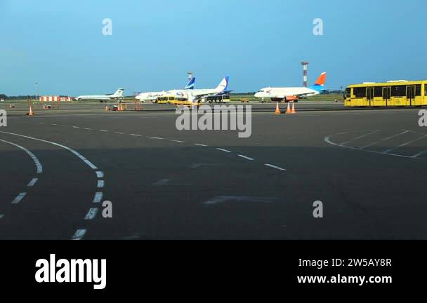 The yellow shuttle bus goes to the planes at a small airport Stock ...